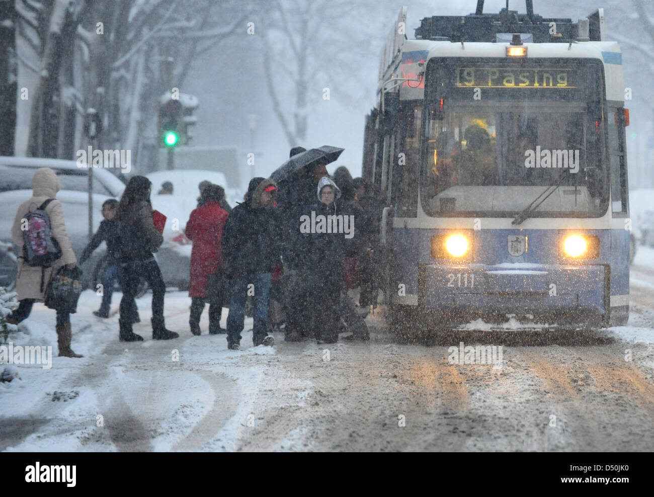 Children cross a snowy street on their way to school in Munich, Germany ...