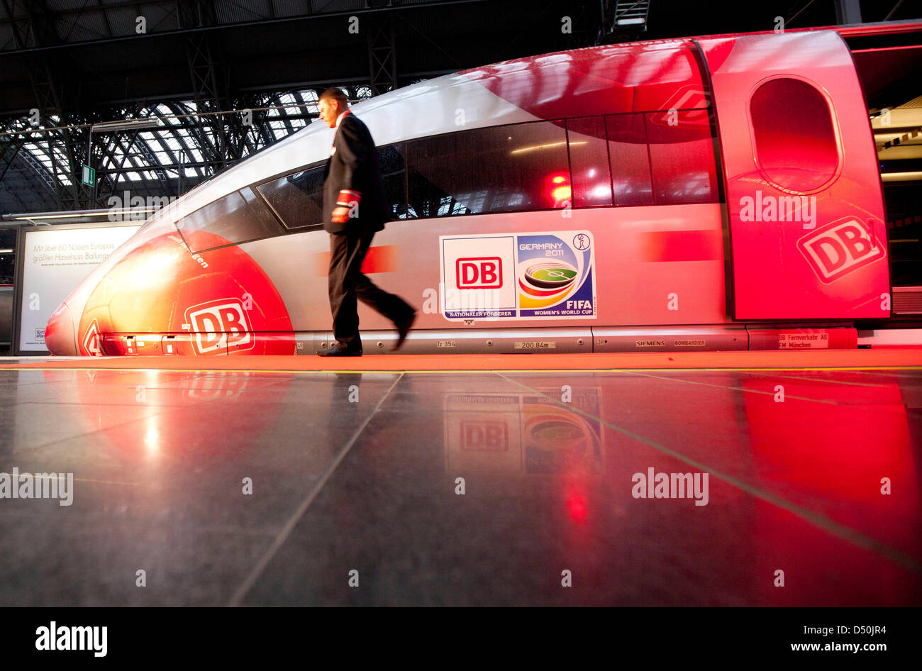 A staff member passes a ICE 3 highspeed train with special design for ...