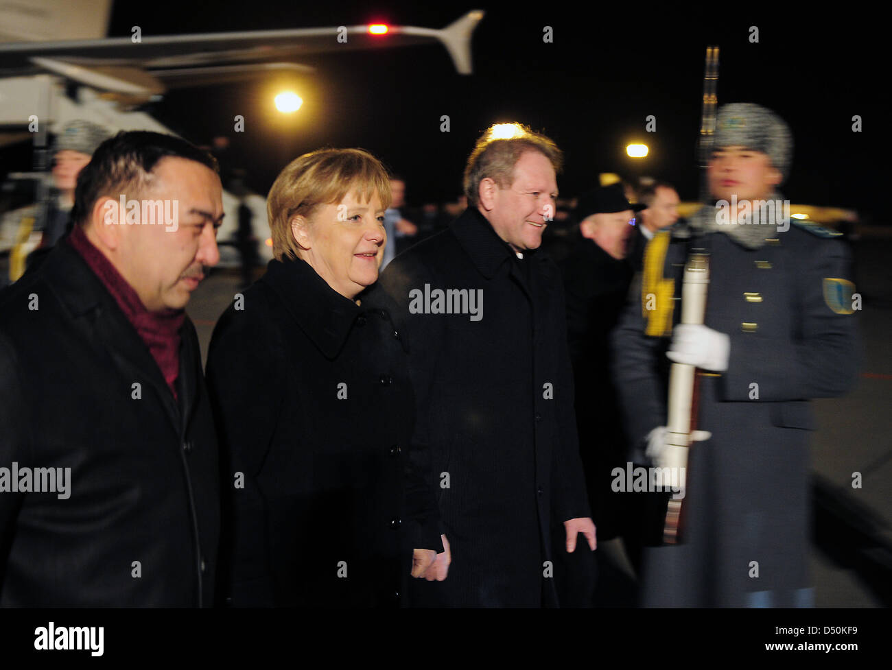 German Chancellor Angela Merkel (2-R) arrives in Astana, Kazakhstan, 30 ...