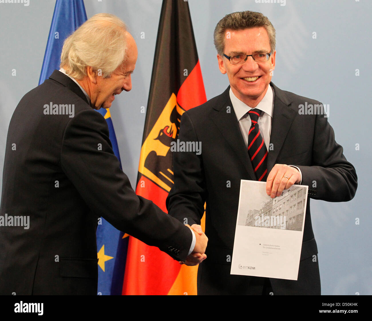 President of BITKOM August-Wilhelm Scheer (L) hands over a draft law ...