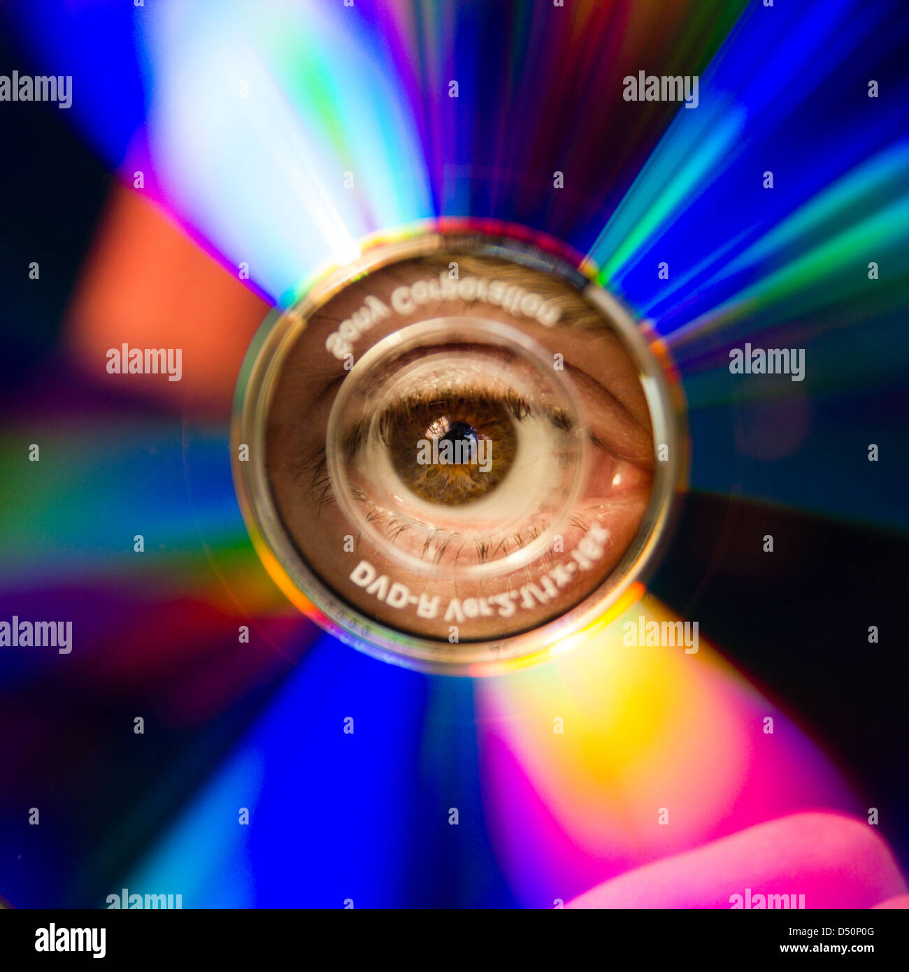 Close up of an eye seen through the hole of a Sony DVD-R Stock Photo ...