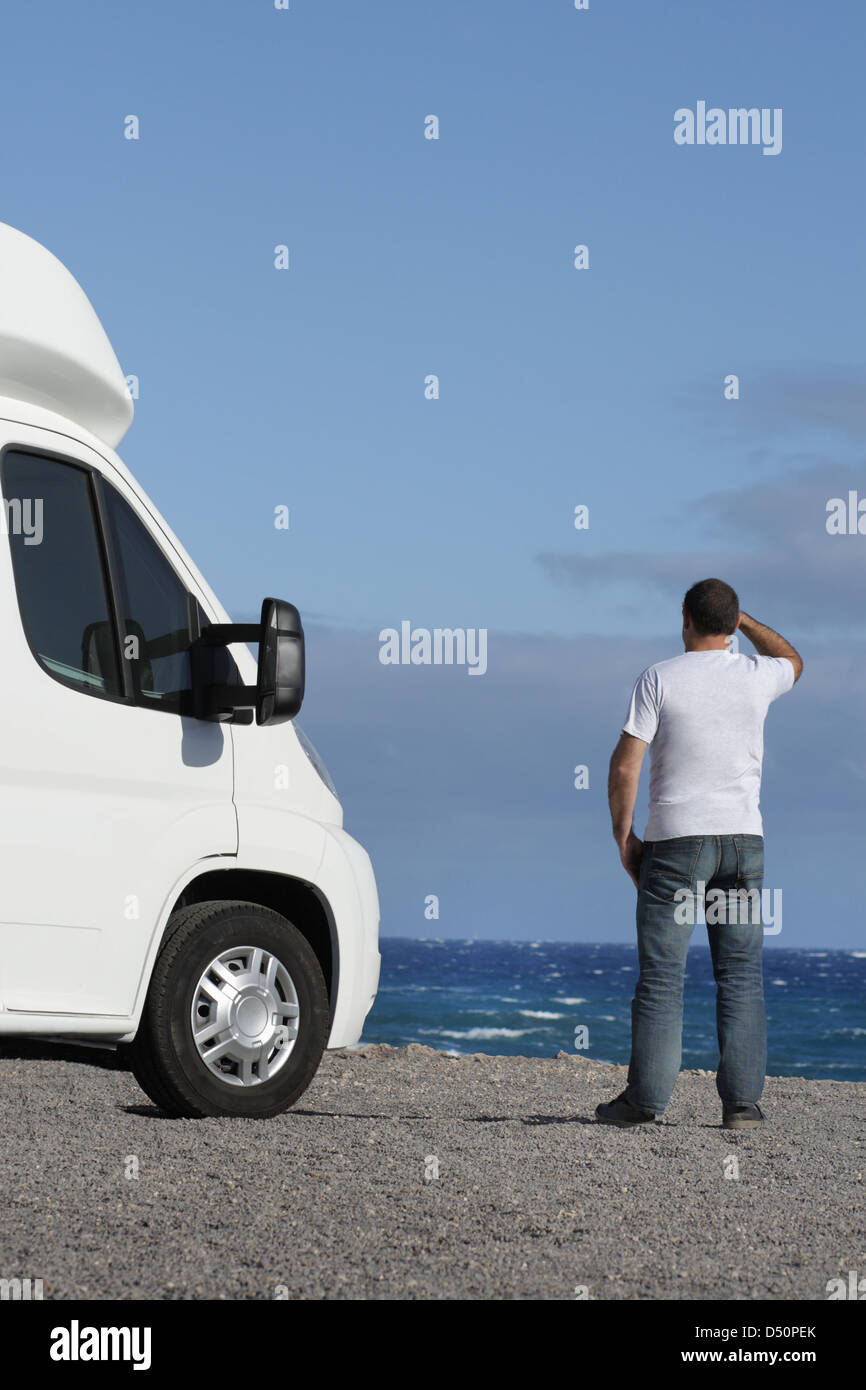 Man with caravan camper at the beach Stock Photo - Alamy