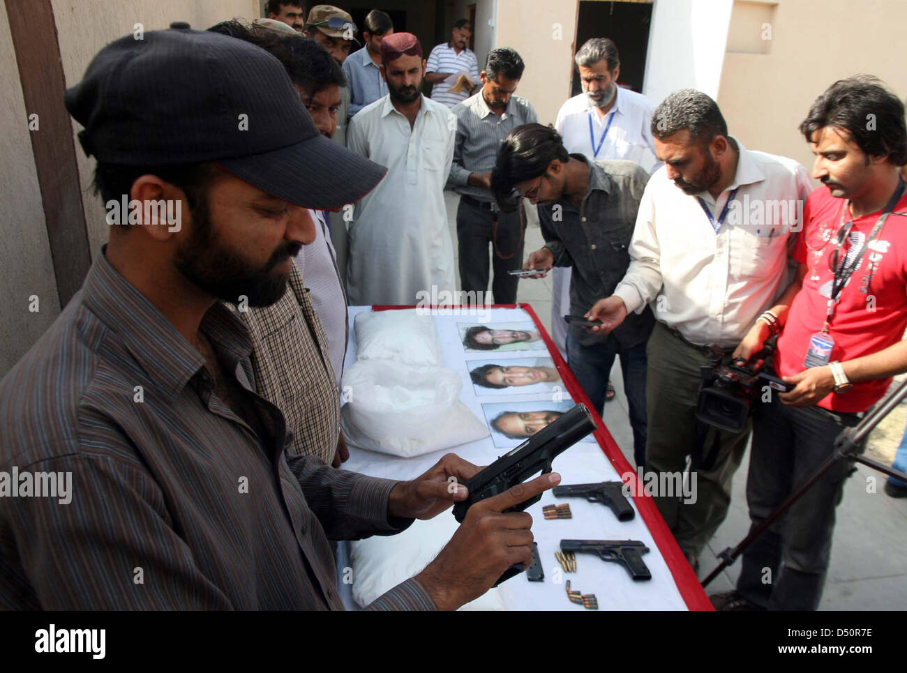 CID Counter Terrorism Wing Officials showing seized weapons during ...
