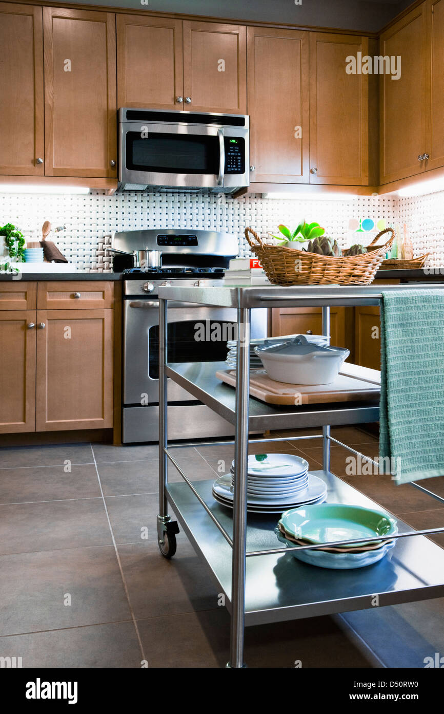Stacks of dishes on chefs cart in domestic kitchen, Tustin, California ...