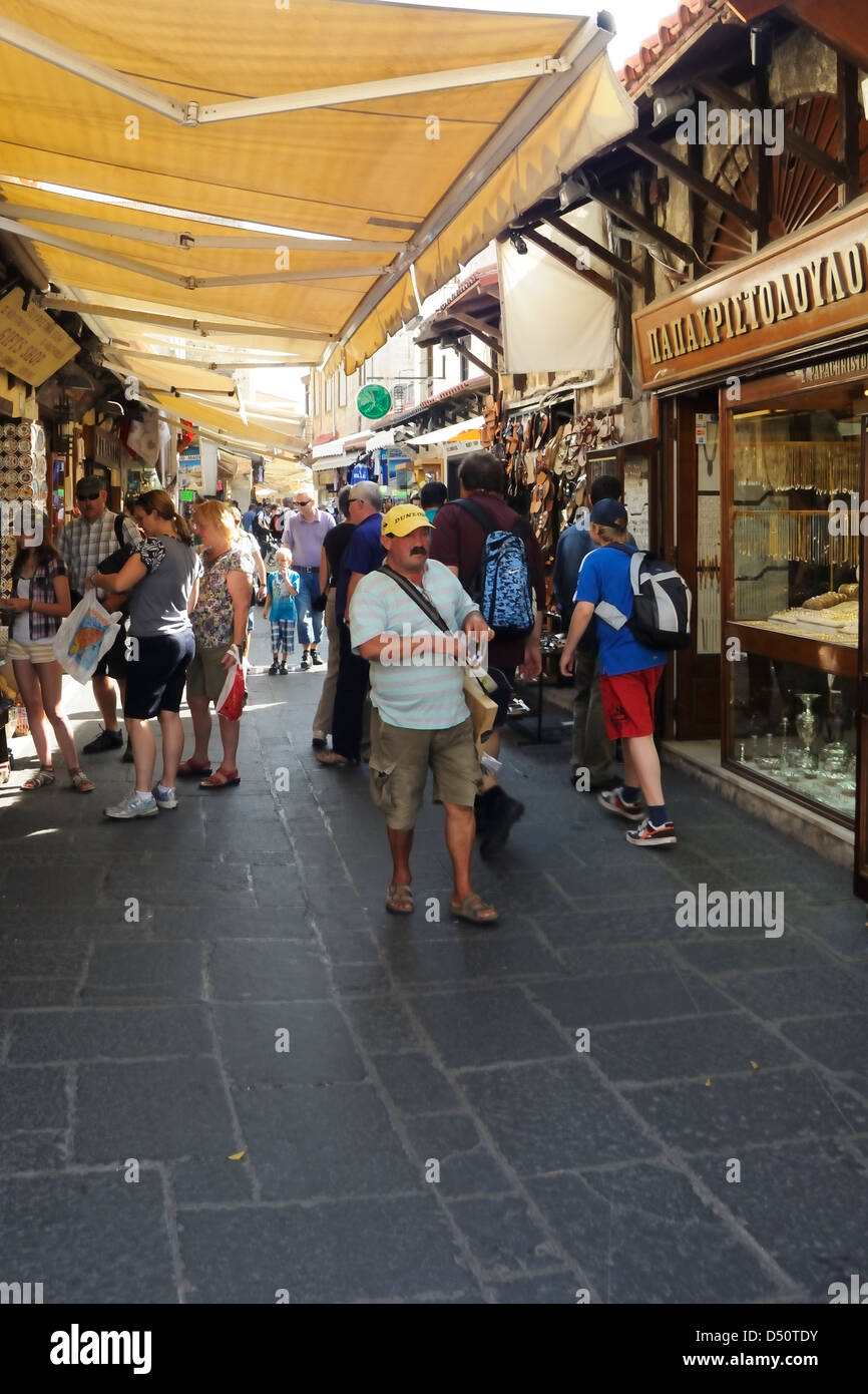 People walking through the narrow market streets of Rhodes Old Town ...