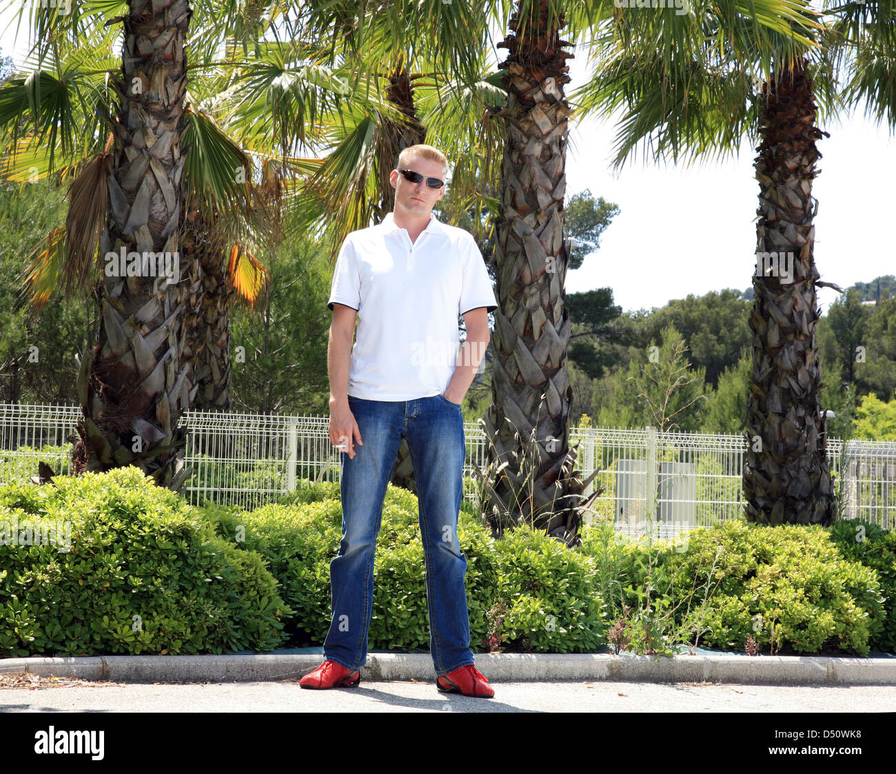 Handsome blond man near palms in France Stock Photo - Alamy
