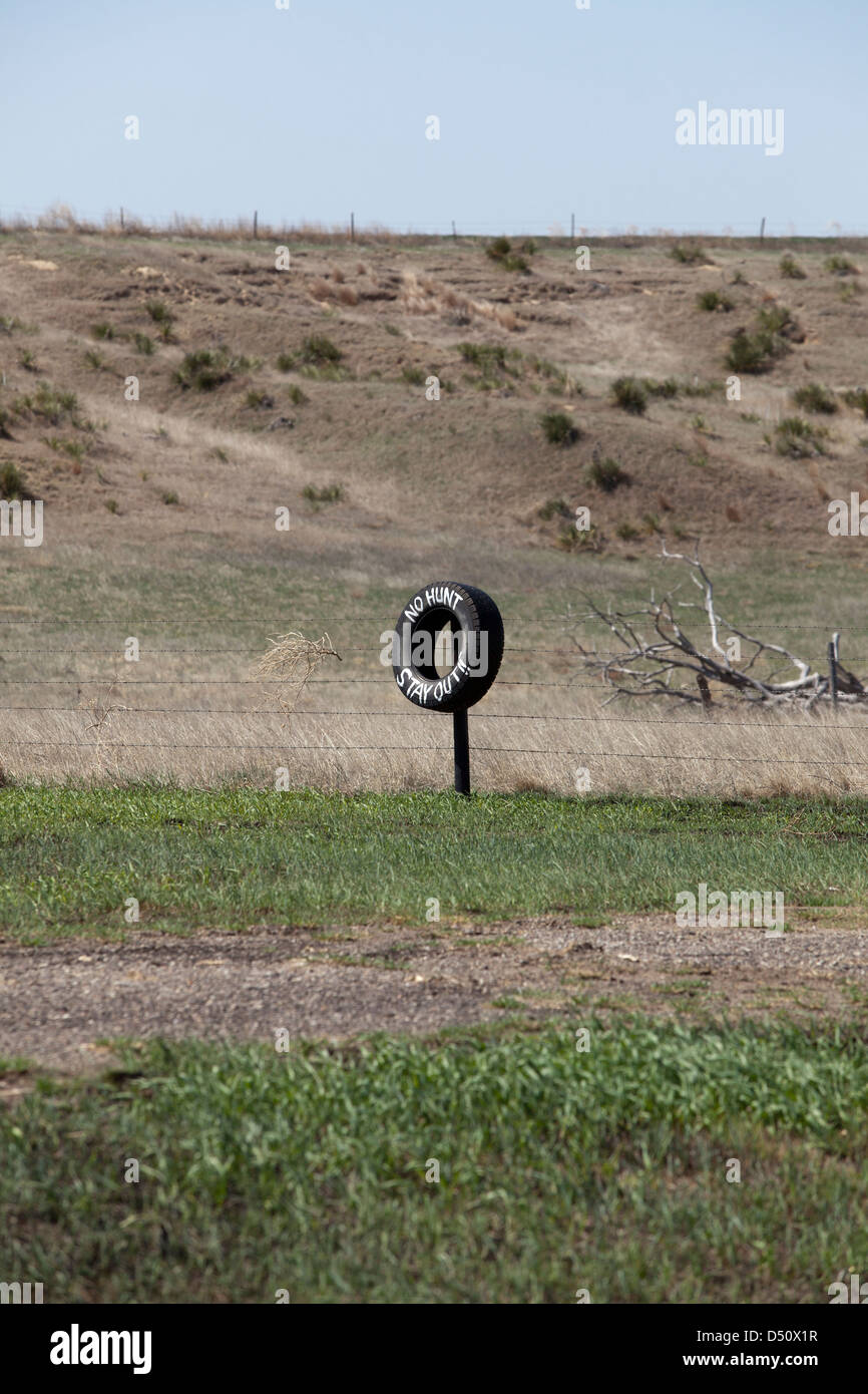 A tire on a pole with No hunt stay out written on it, Oakley,Kansas ...