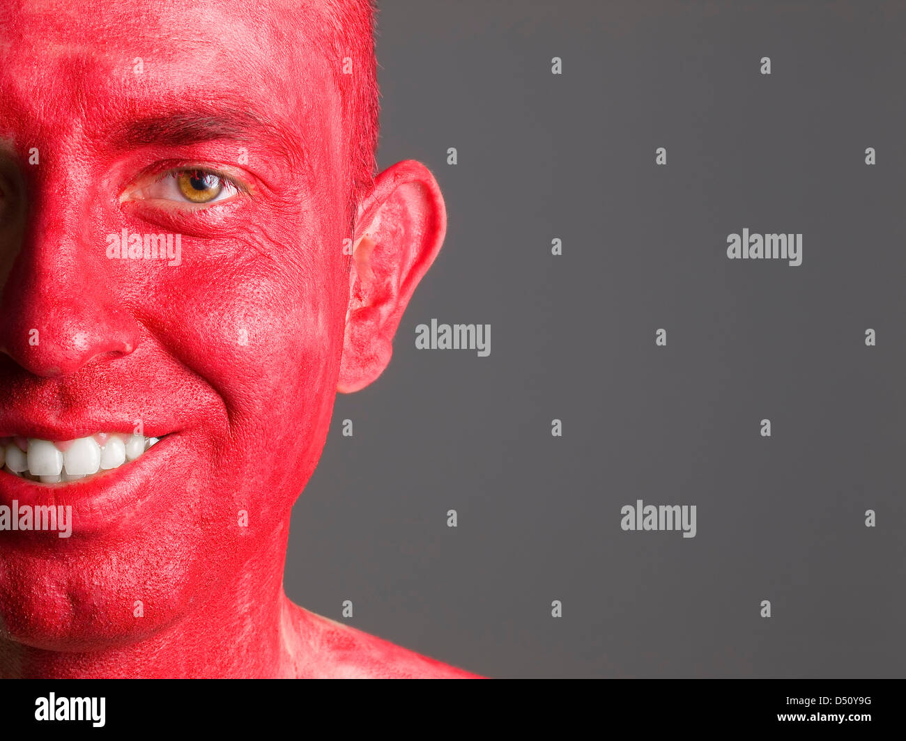 Face smiling man makeup red isolated on dark background Stock Photo - Alamy
