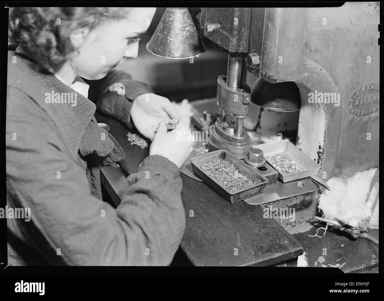 A worker operates a Hamilton Watch machine in Lancaster, Pennsylvania ...