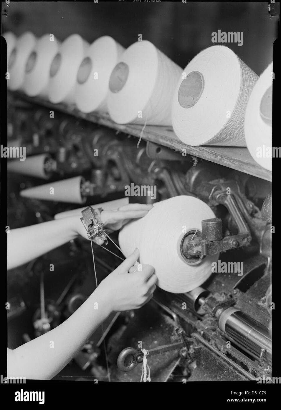 This January 1937 photo by Lewis Hine captures a close-up of a winder ...