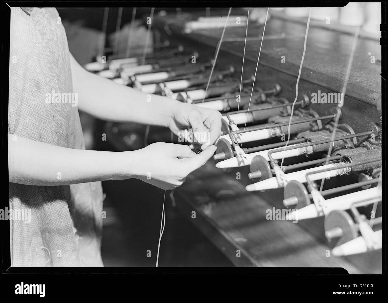 In March 1937, Lewis Hine captured Quiller tying thread onto quills in ...