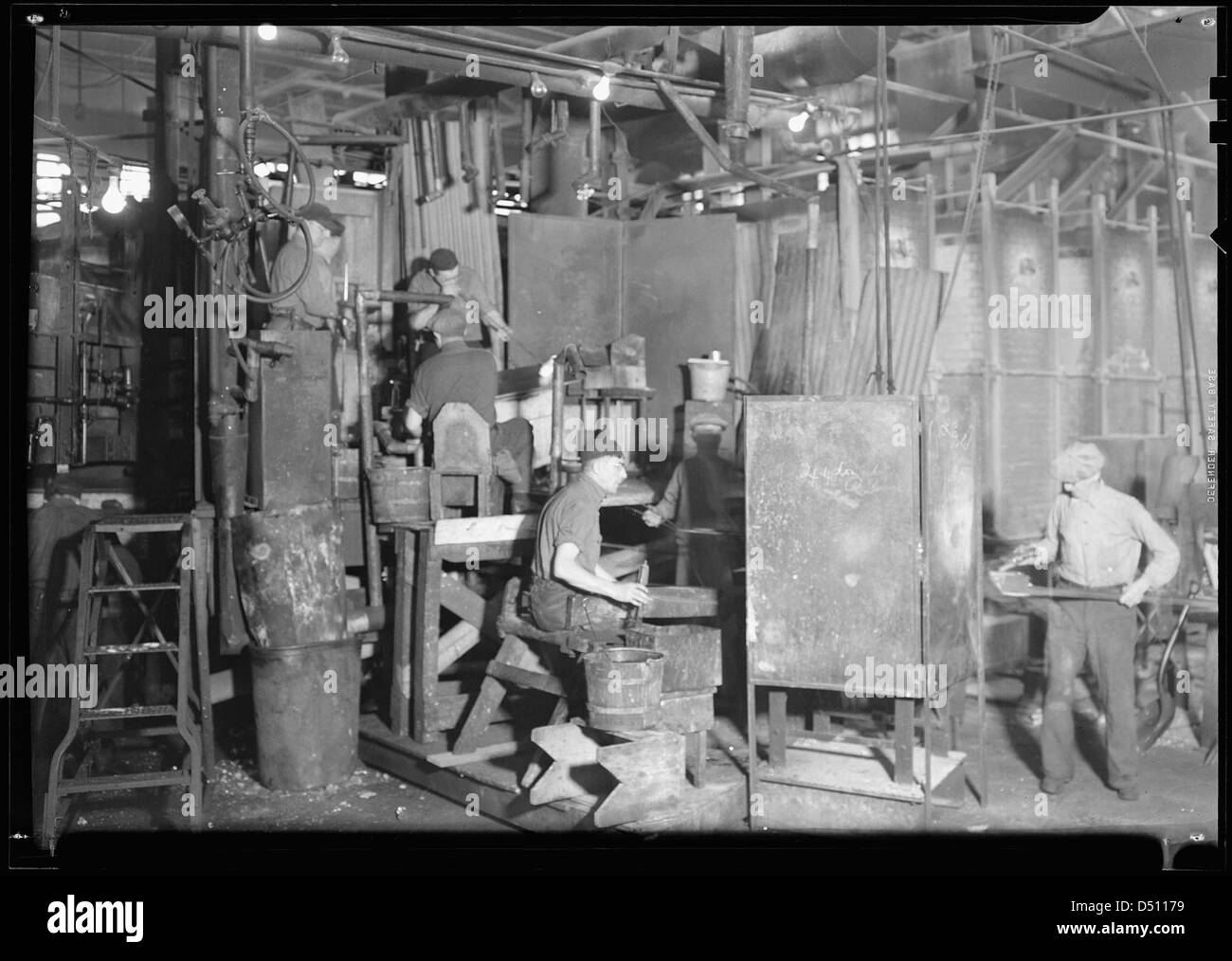 Men work at ovens in a factory in Millville, New Jersey, in March 1937 ...