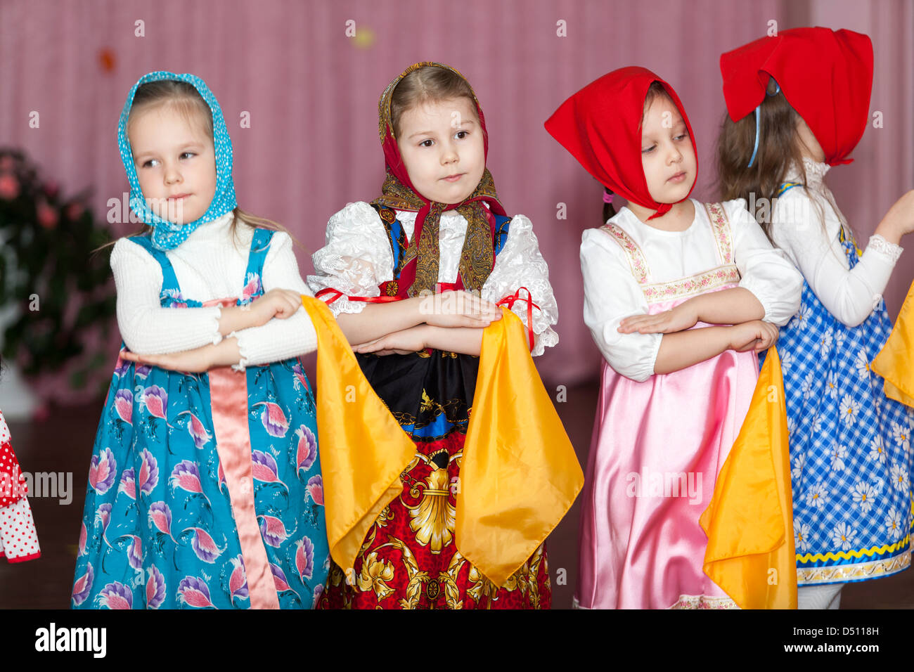 Preschooler girls dancing on the stage in Russian traditional clothes ...
