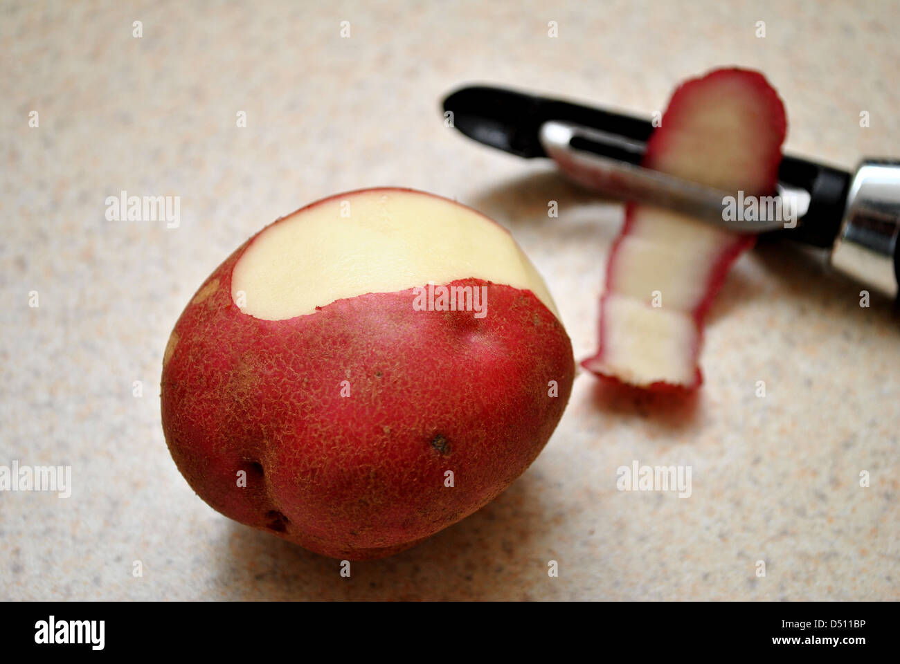 Peel raw potato vegetable peeler hi-res stock photography and images ...