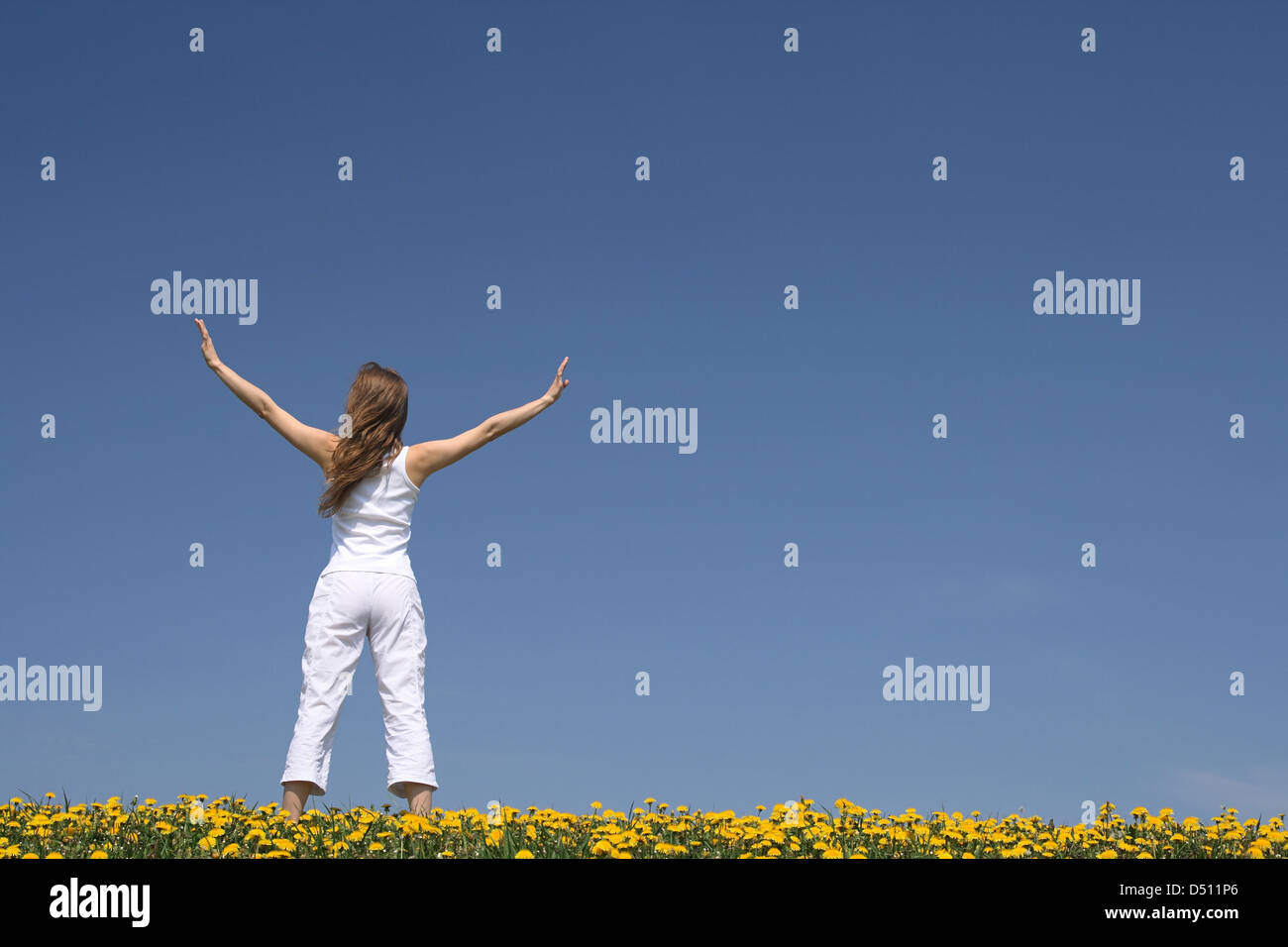Young woman exercising outdoors, in a flowering spring field Stock ...
