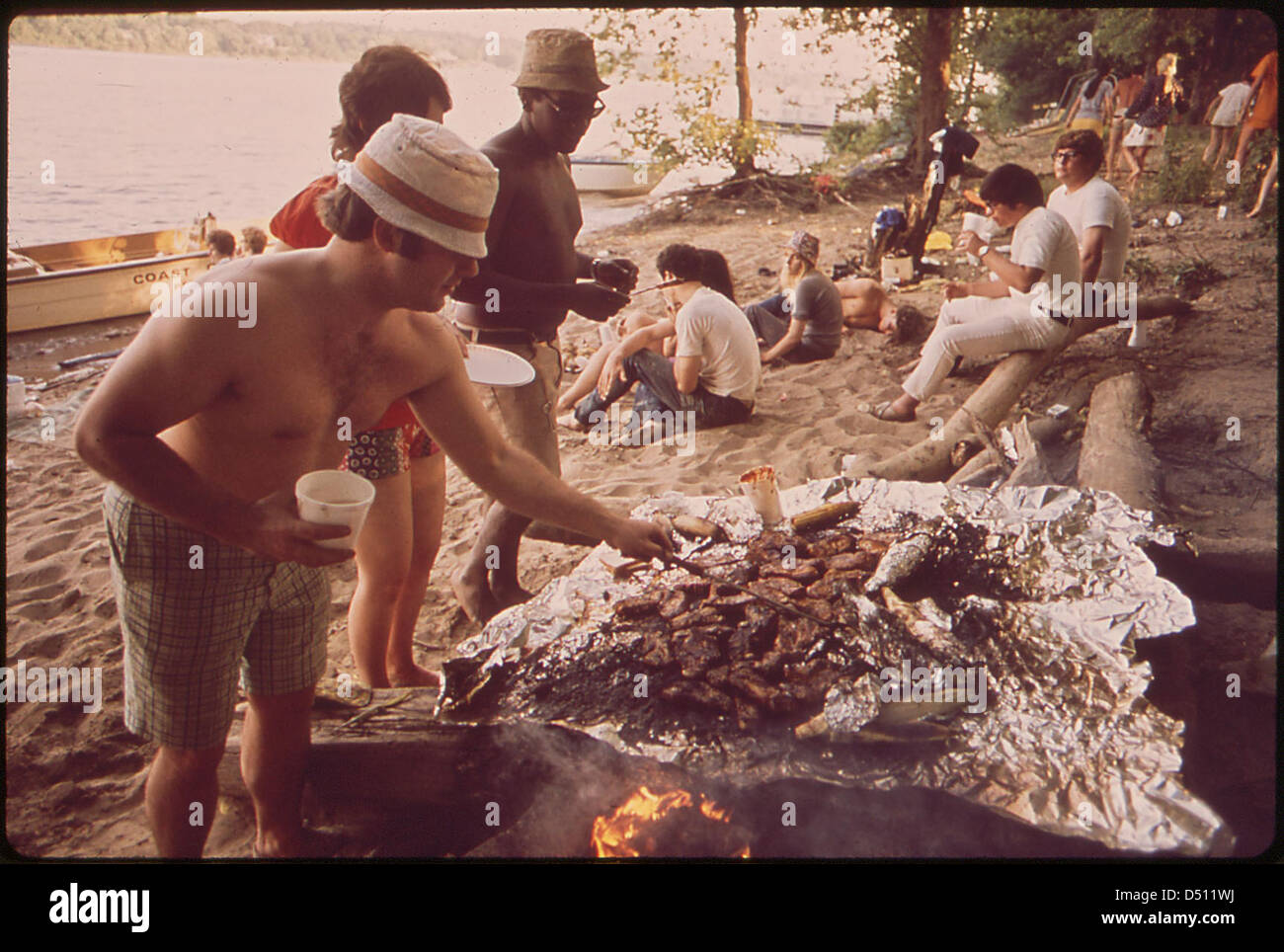 In June 1972, people enjoy a picnic on the banks of the Ohio River, as captured by William ...