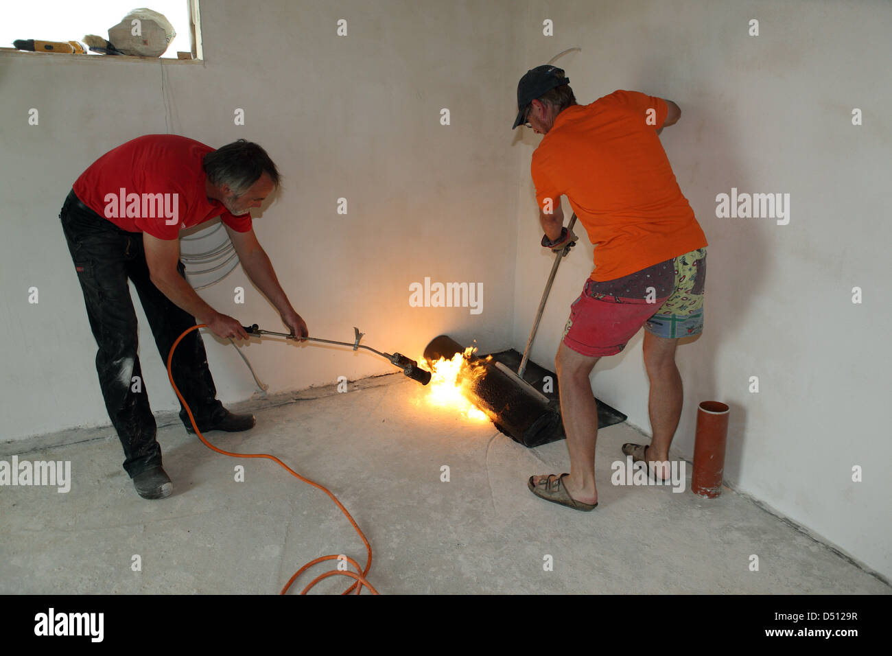 New Kätwin, Germany, Men lay tar paper with a gas heating torch Stock ...