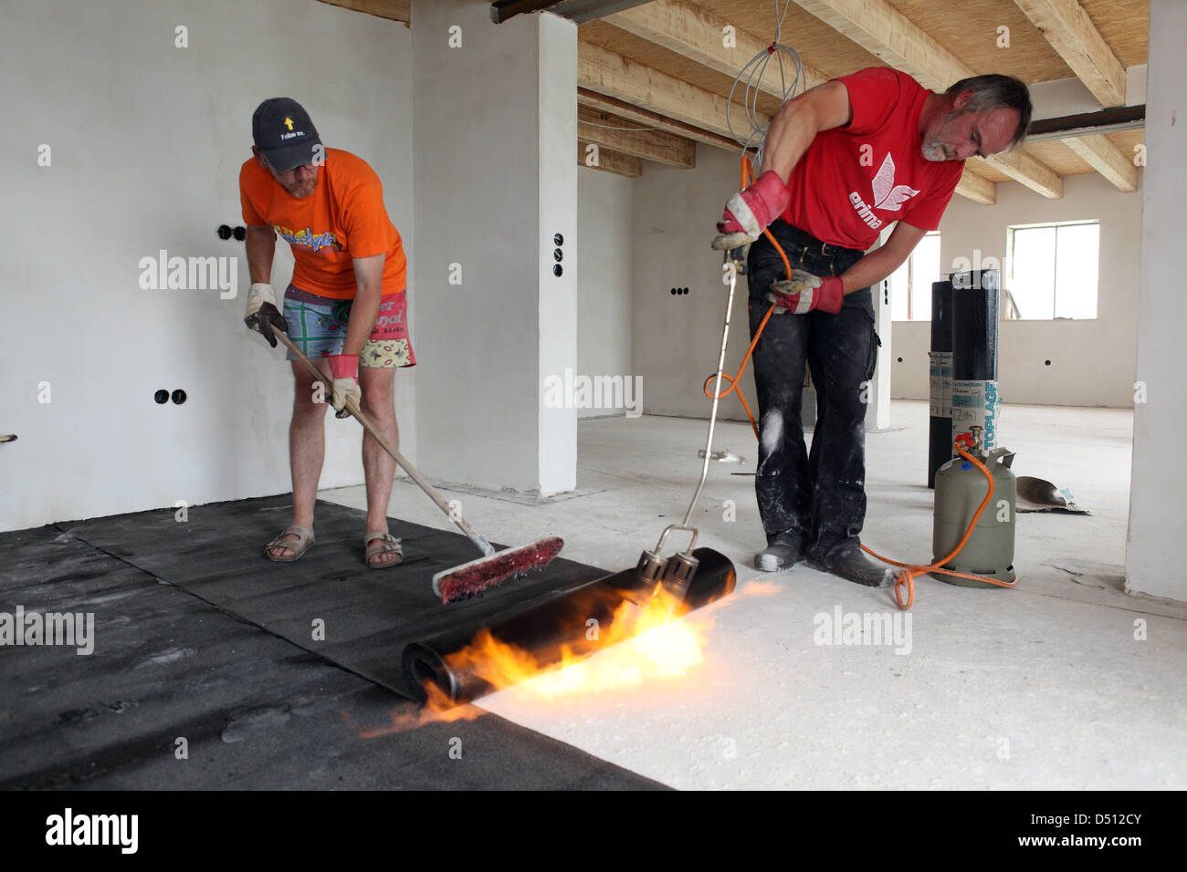New Kätwin, Germany, Men lay tar paper with a gas heating torch Stock ...