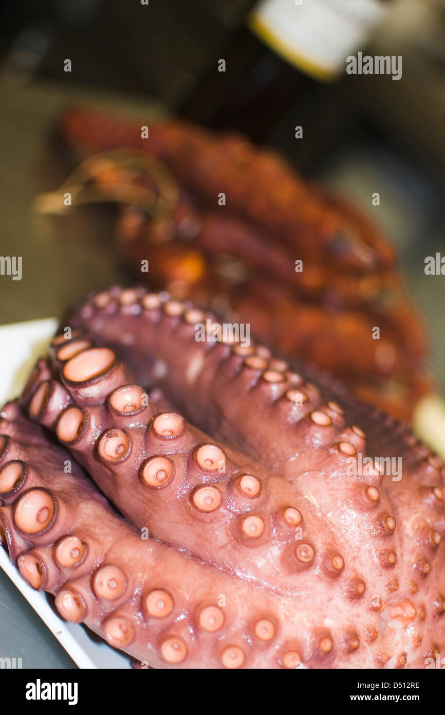 octopus cooked and presented in the table with accessories Stock Photo ...
