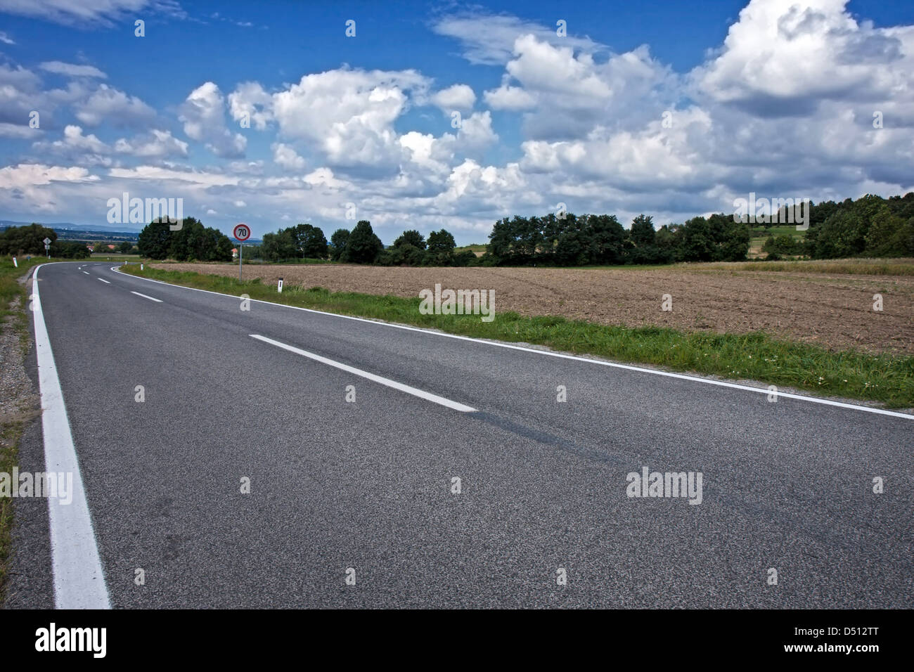Straight asphalt road leading into the distance Stock Photo - Alamy