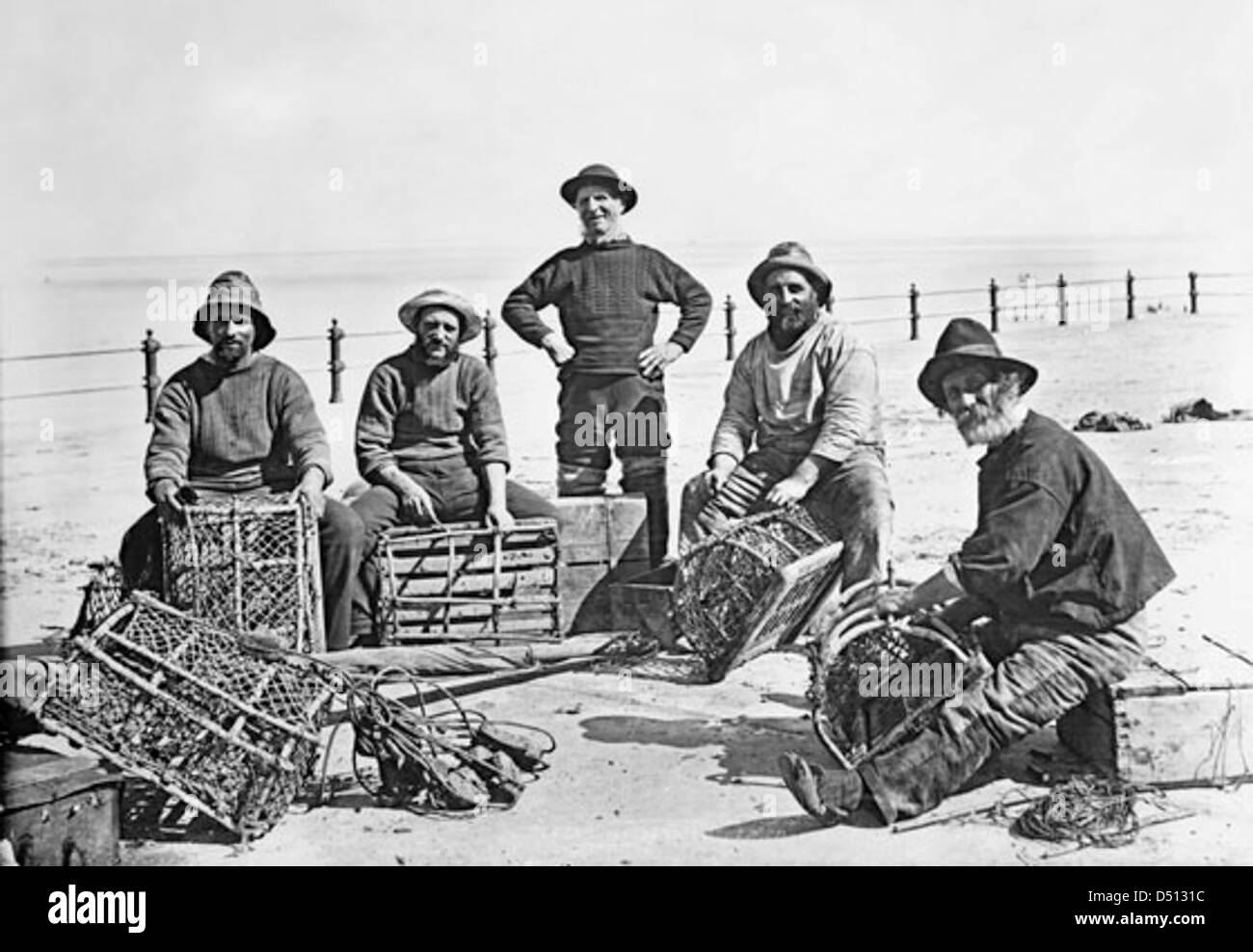 Fishermen are pictured with their lobster pots in Sheringham, Norfolk ...