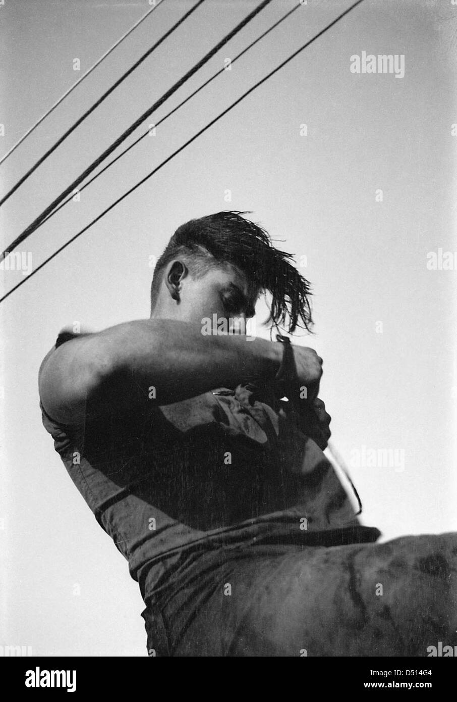 This image shows a member of the crew using a sailmaker's palm, an ...
