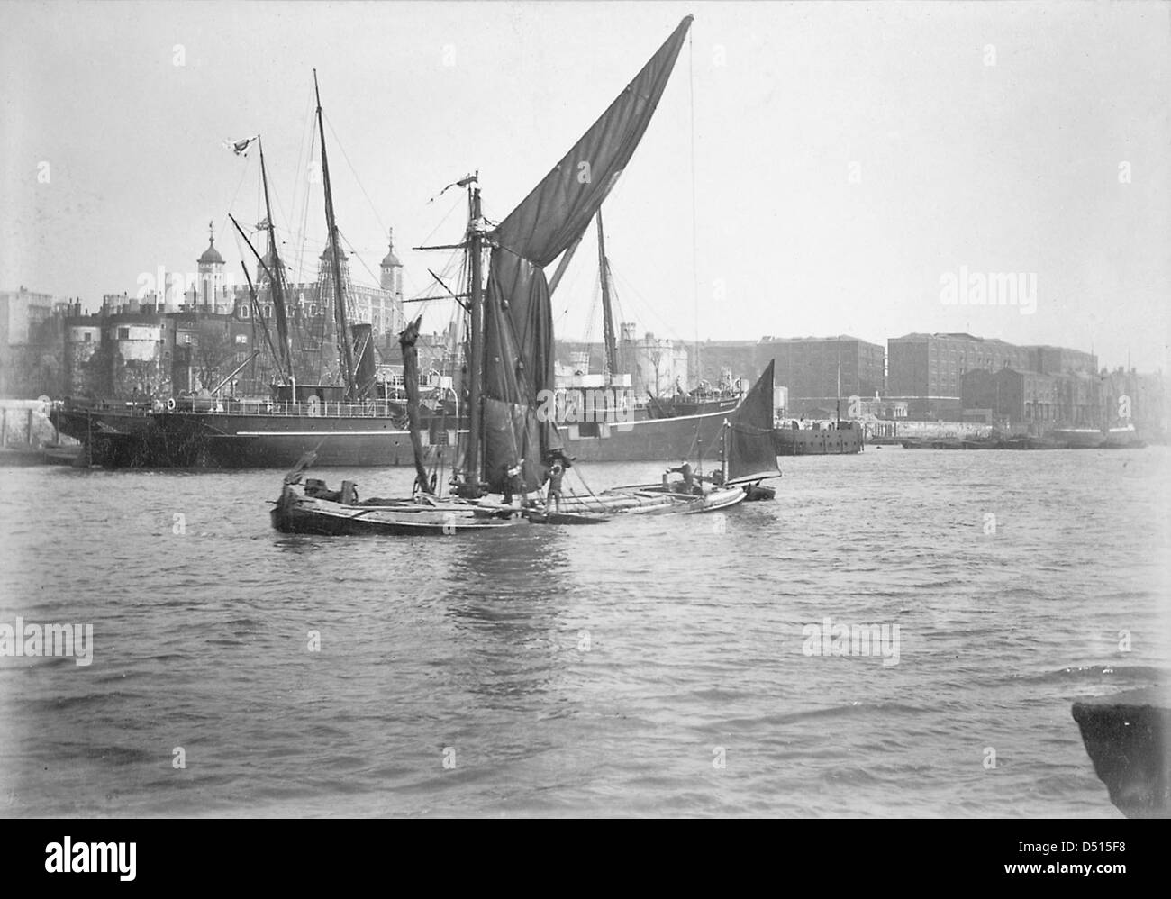 A sailing barge is shown passing the Tower of London in this historic ...