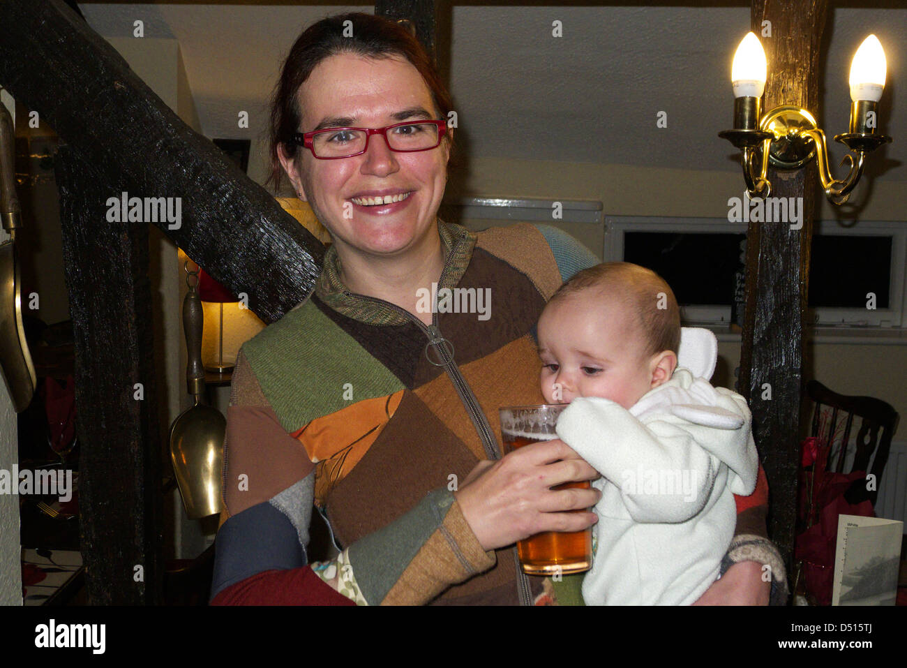 A baby drinking beer in a pub in England Stock Photo - Alamy