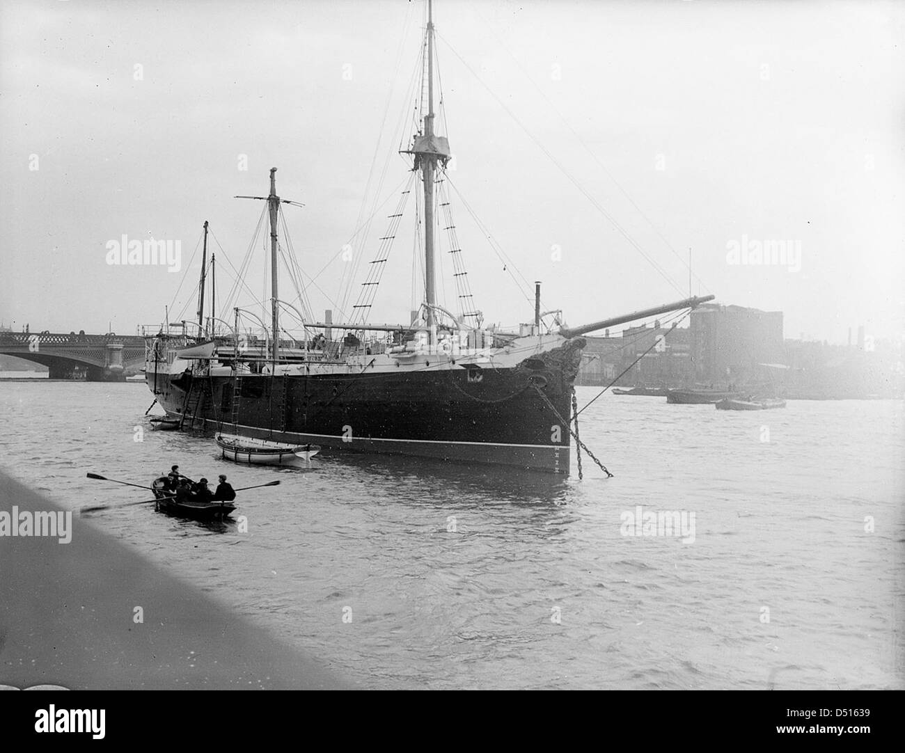 A historical photograph showing the RNVR Training Ship 'Buzzard' moored ...