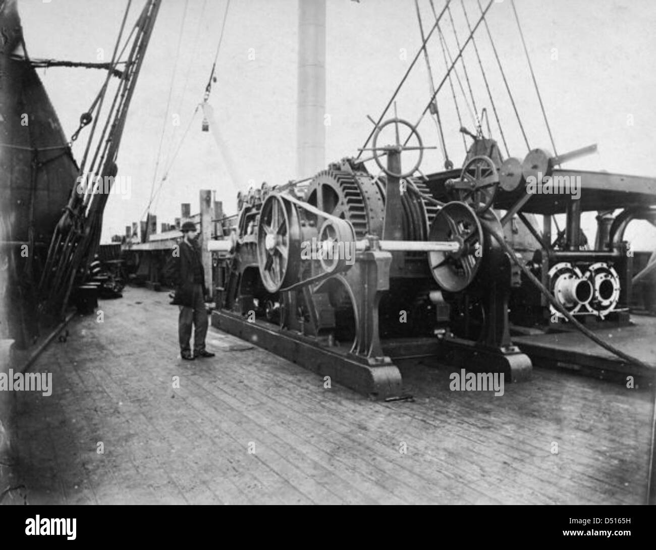 This photograph shows an engineer standing next to the cable laying ...