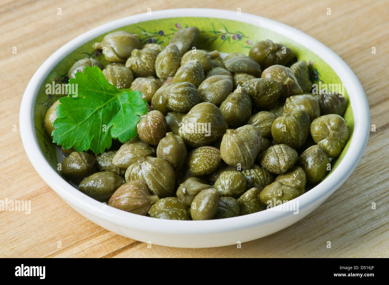 capers in plate on wood table Stock Photo - Alamy