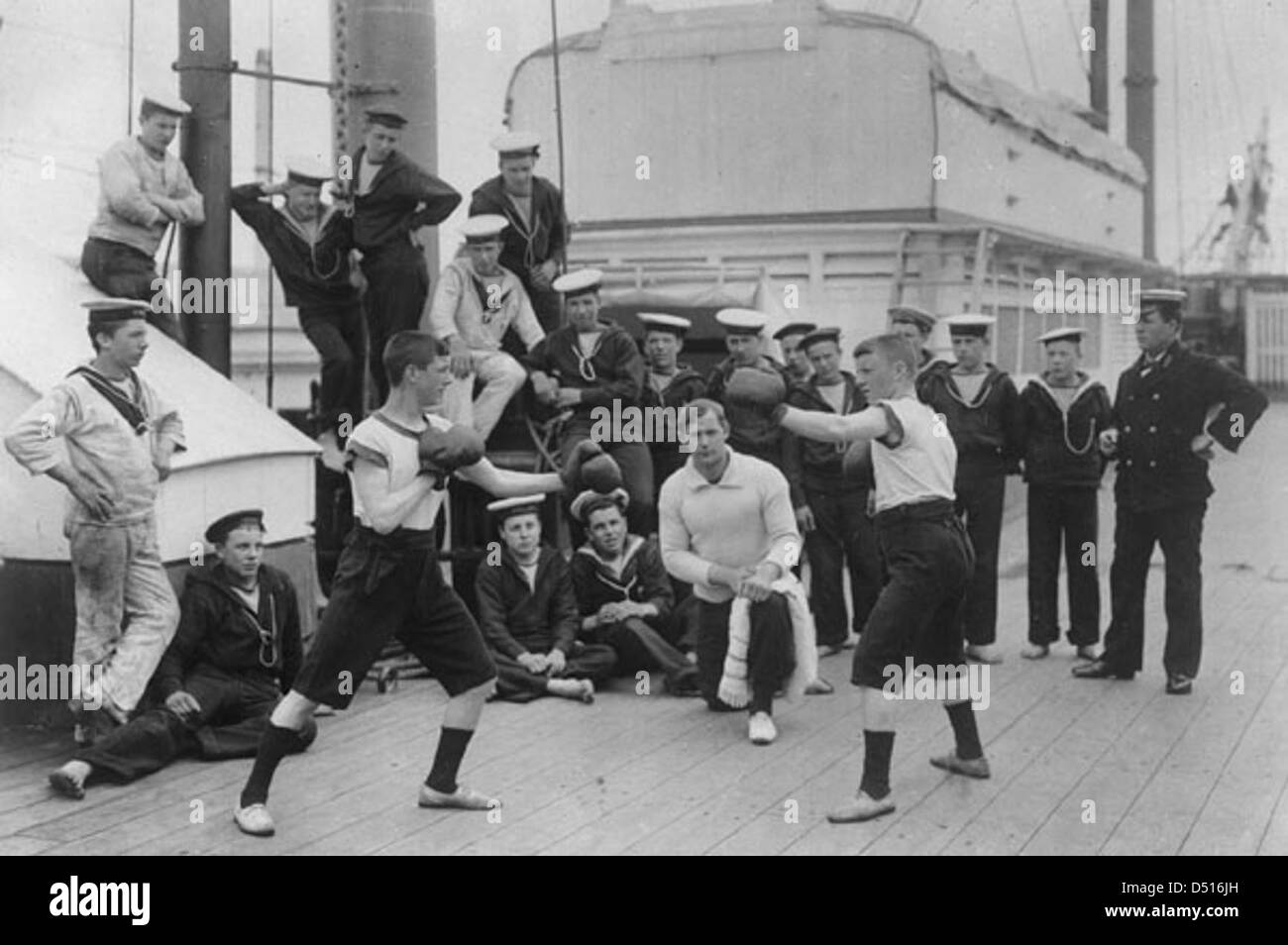 This historical image shows two boys boxing on the deck of the 'Lion ...