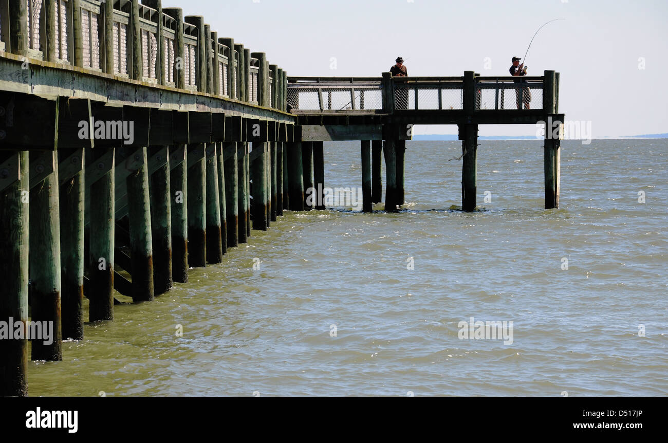 Salt Water Fisherman fishing off of an ocean pier Stock Photo - Alamy