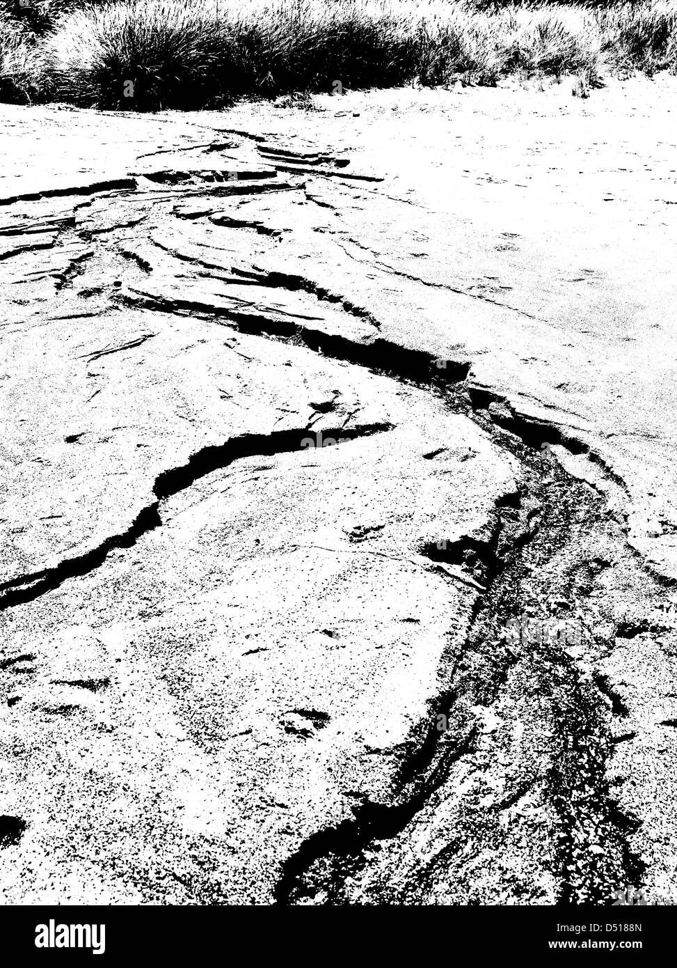 High contrast image of a rivulet's erosion of sand on a beach Stock ...