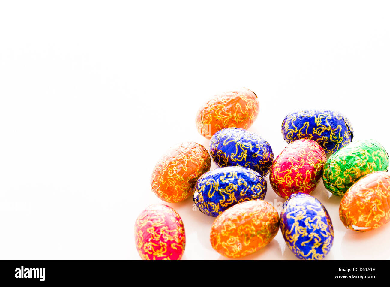 Chocolate eggs wrapped in bright foils on a white background Stock ...