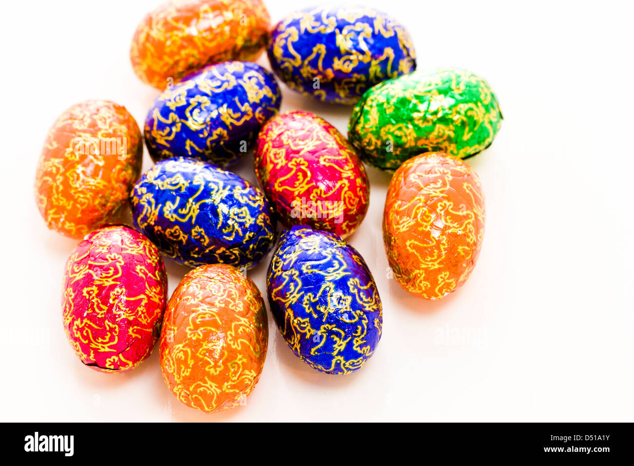 Chocolate eggs wrapped in bright foils on a white background Stock ...