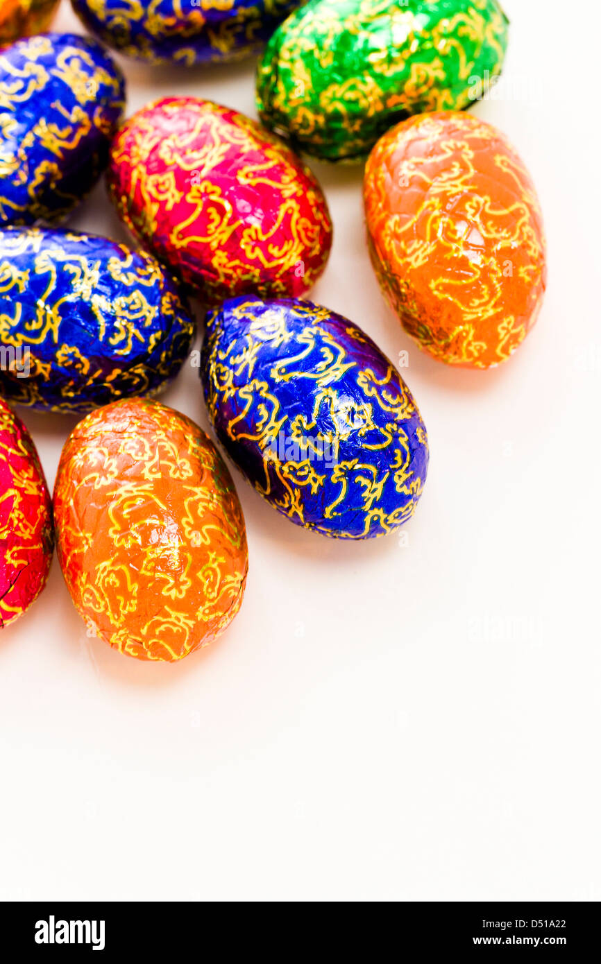 Chocolate eggs wrapped in bright foils on a white background Stock ...