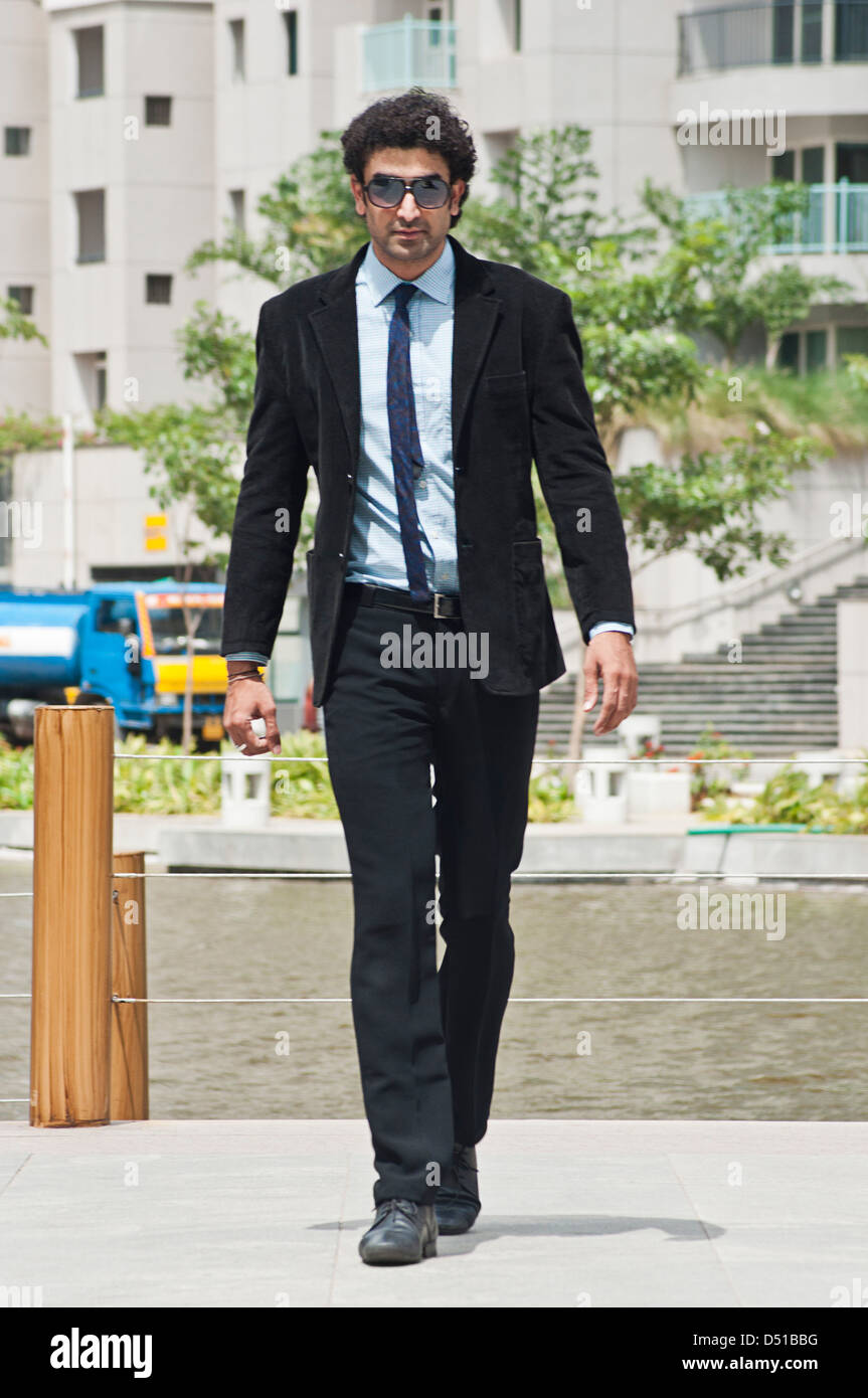 Businessman walking at poolside Stock Photo - Alamy