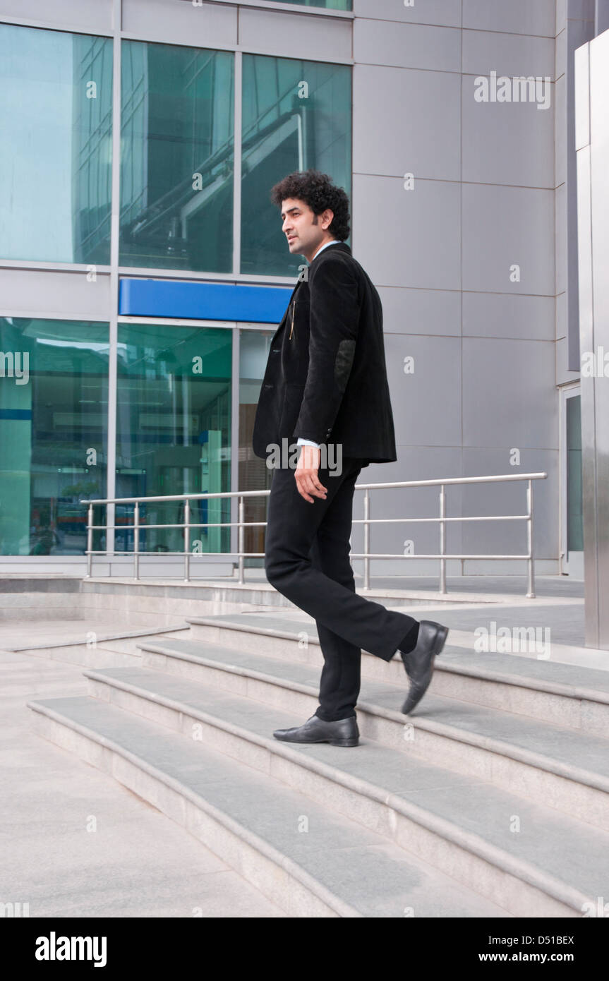 Businessman moving down on steps Stock Photo - Alamy