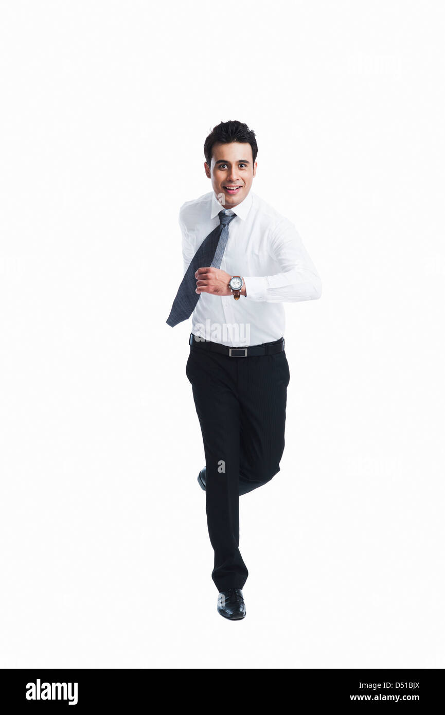 Businessman running and smiling Stock Photo - Alamy