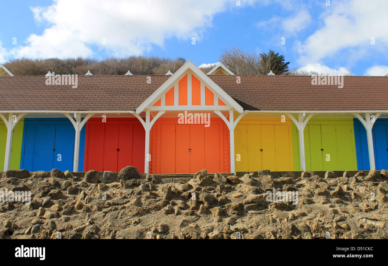 Row of colorful beach chalets with blue sky and cloudscape background ...