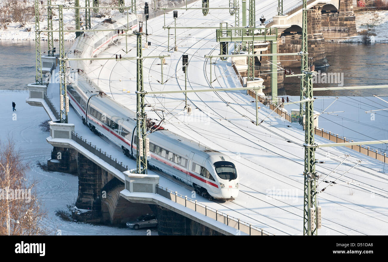 An ICE train crosses the snow-covered Marienbruecke (Mary's Bridge) in ...