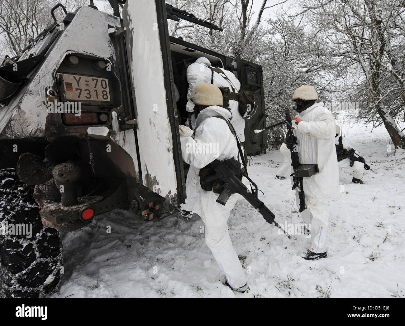 Soldiers of the German-French brigade enter a troop carrier of the type ...