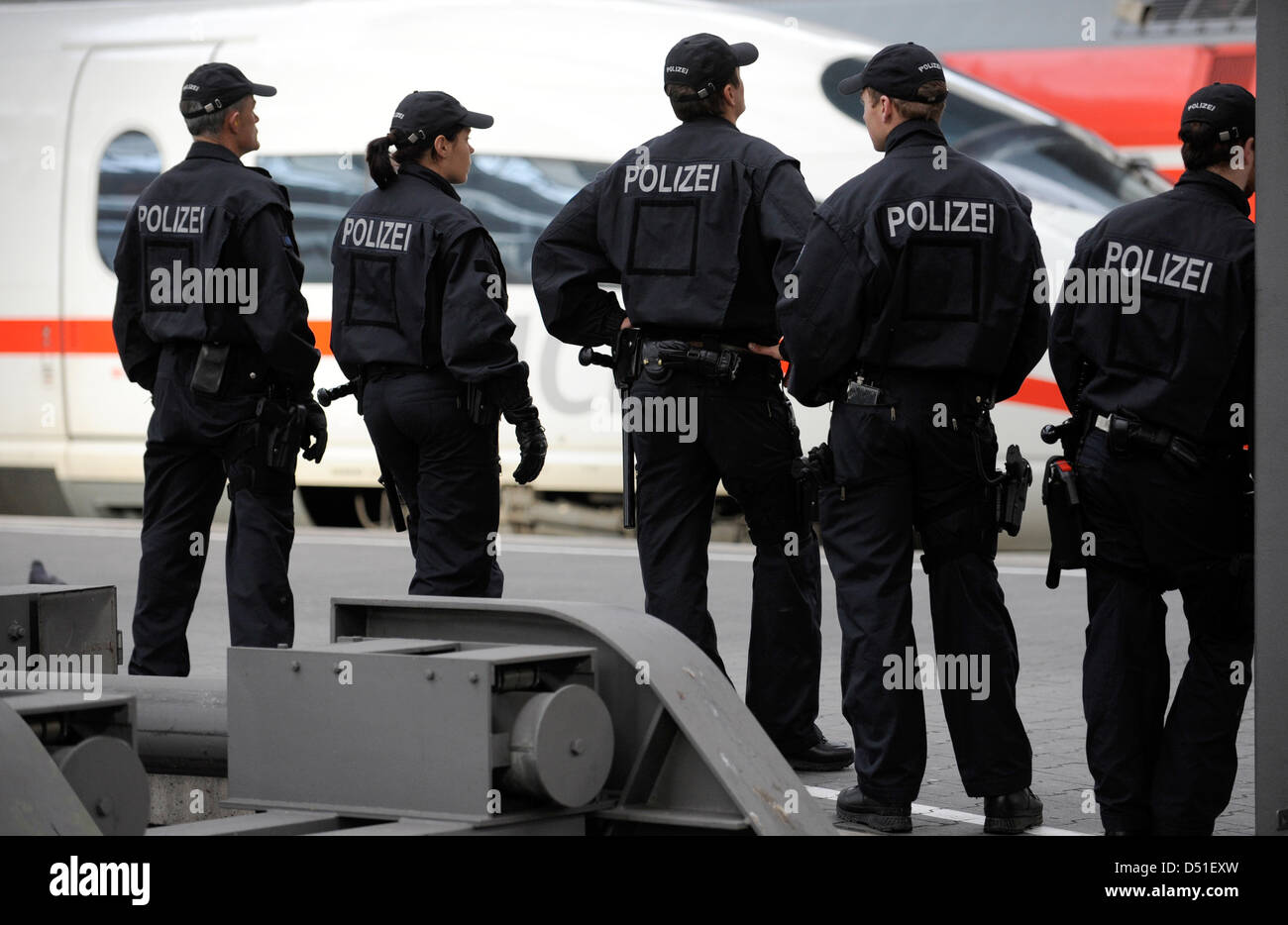 Several police officers stand at the train station to prevent riots of ...