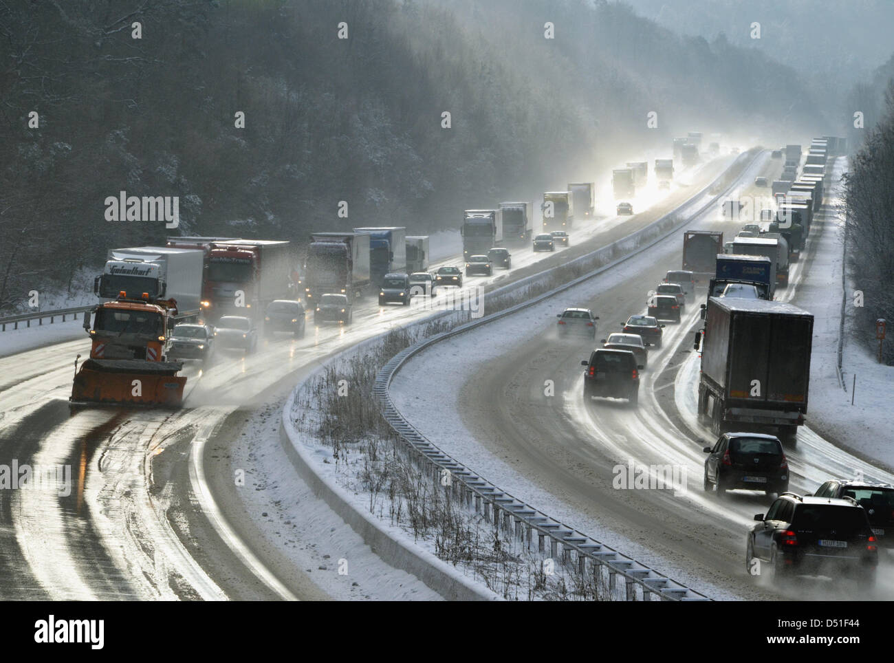 A snow plow clears the A7 motorway between Kassel and Wuerzburg near ...