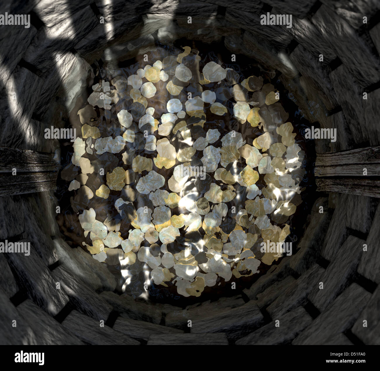 A top view looking into a brick wishing well with gold silver and ...