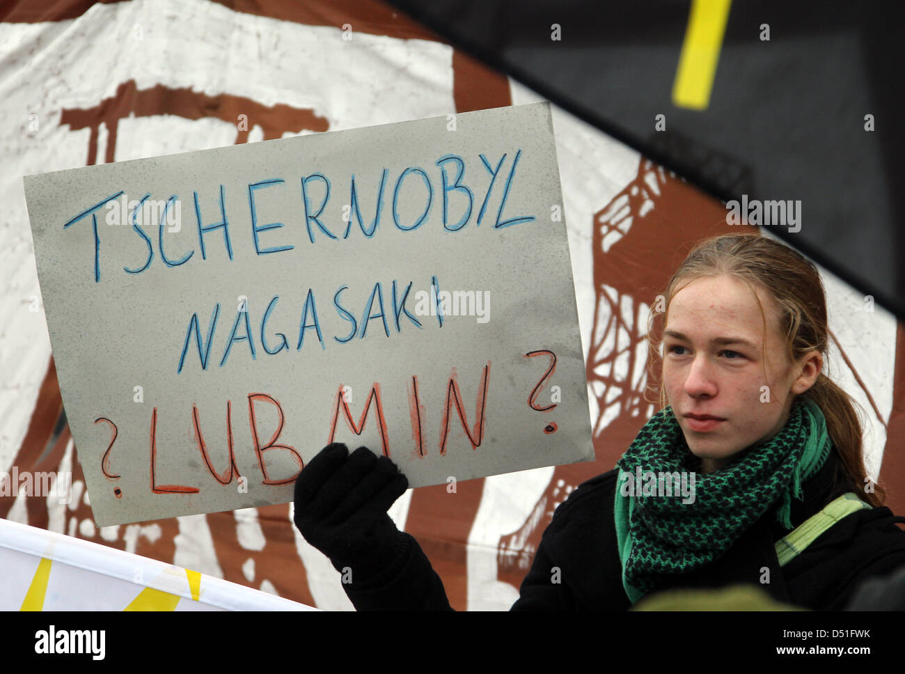 People hold handwritten signs and protest against nuclear waste ...