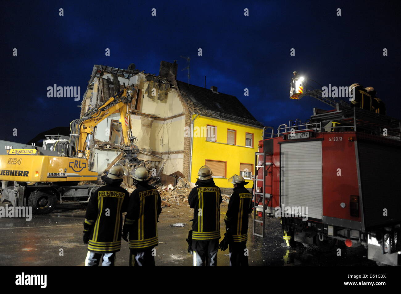 Rescue forces stand in front of a collapsed house after a gas explosion ...