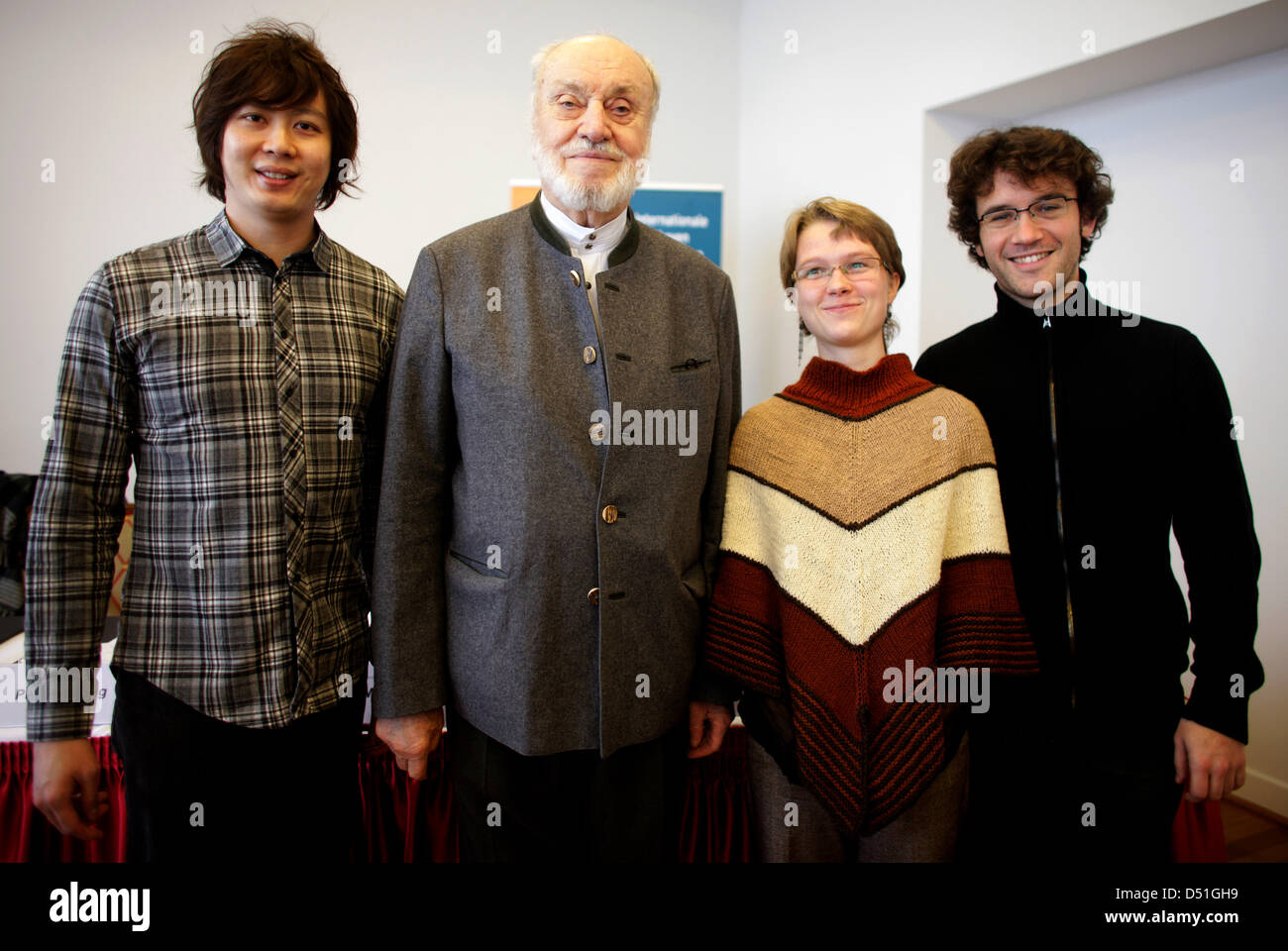 German maestro Kurt Masur (2-L) smiles with the three young conductors ...