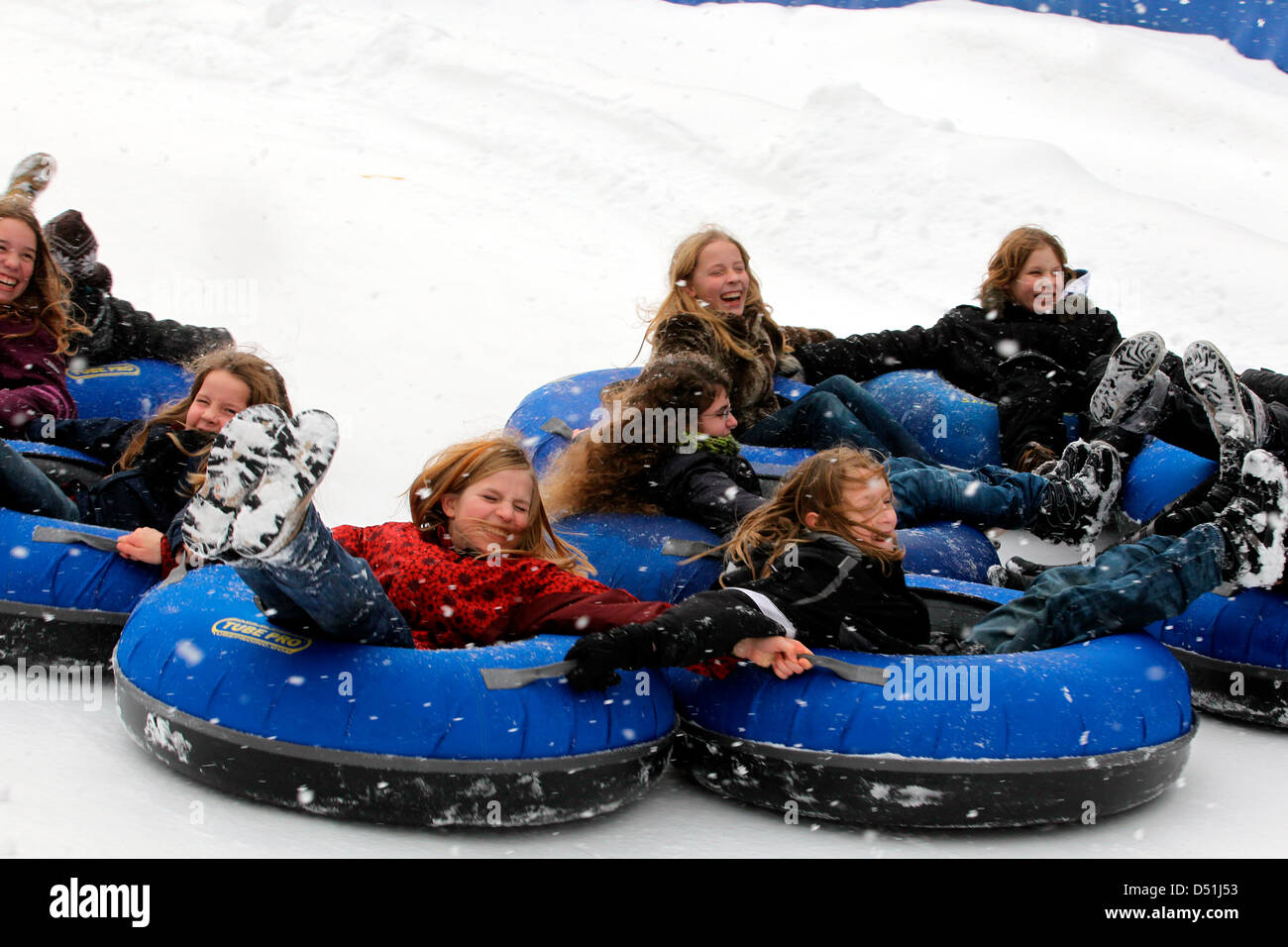 Children have fun at an artificial sled-riding hill at Potsdamer Platz ...